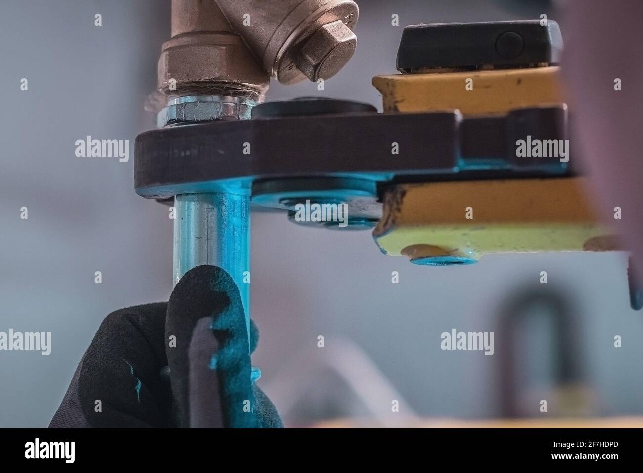 Plumber using pipe fastener or battery press tool to crimp heating or ...