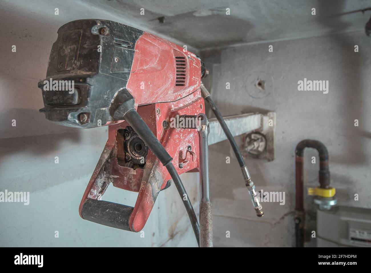 Machine for drilling holes in hthe concrete wall. Red professional ...
