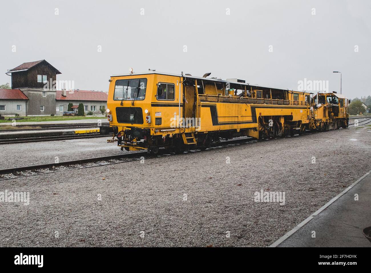 Railway work train on a station in a foggy rainy morning Stock Photo ...