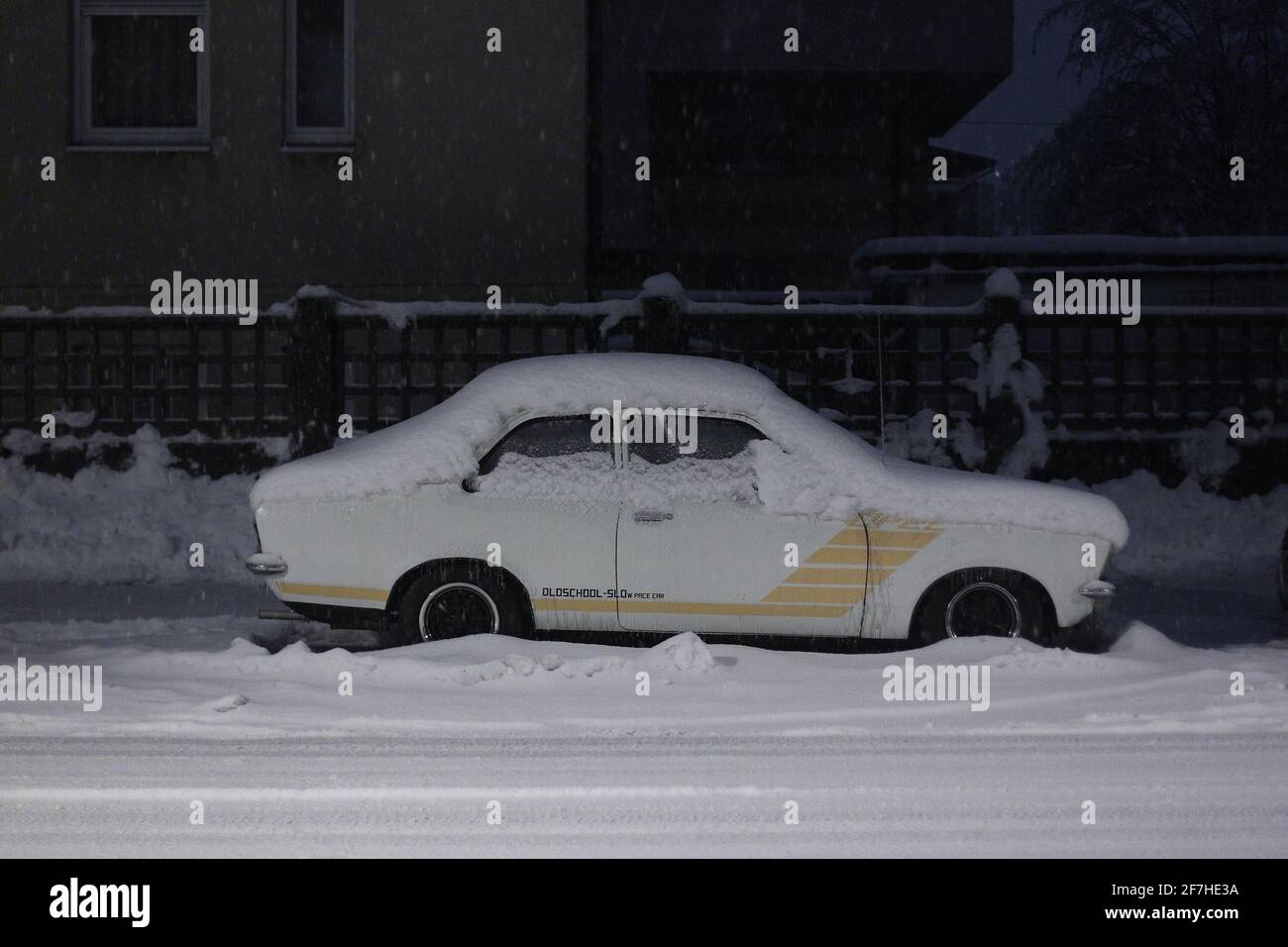 An old vintage car under a thick layer of snow in the night Stock Photo ...