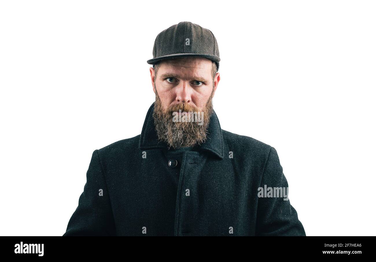 Angry looking hipster man with a beard and a baseball hat wearing a ...