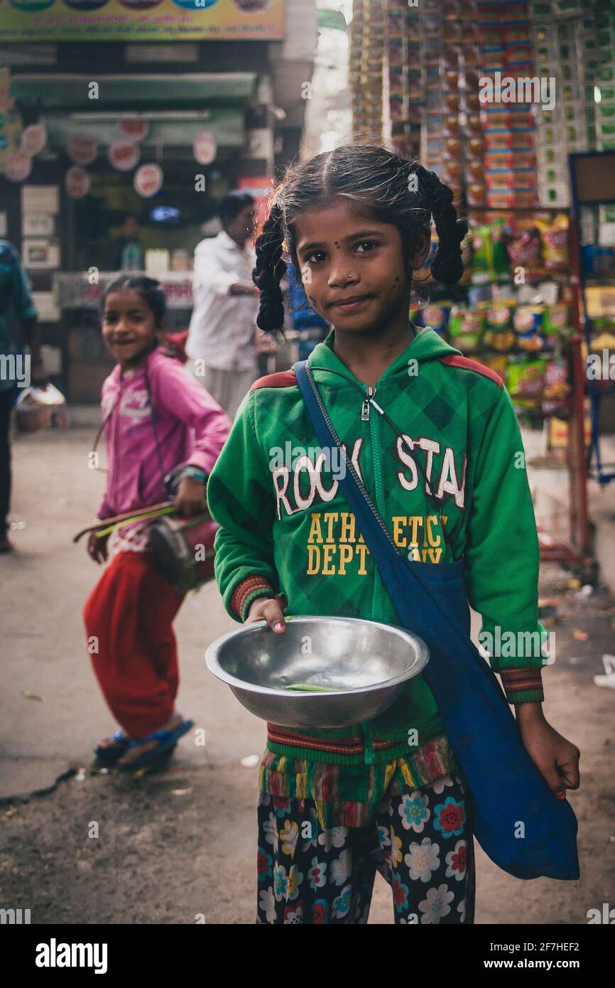 Girl beggar holding bowl hi-res stock photography and images - Alamy