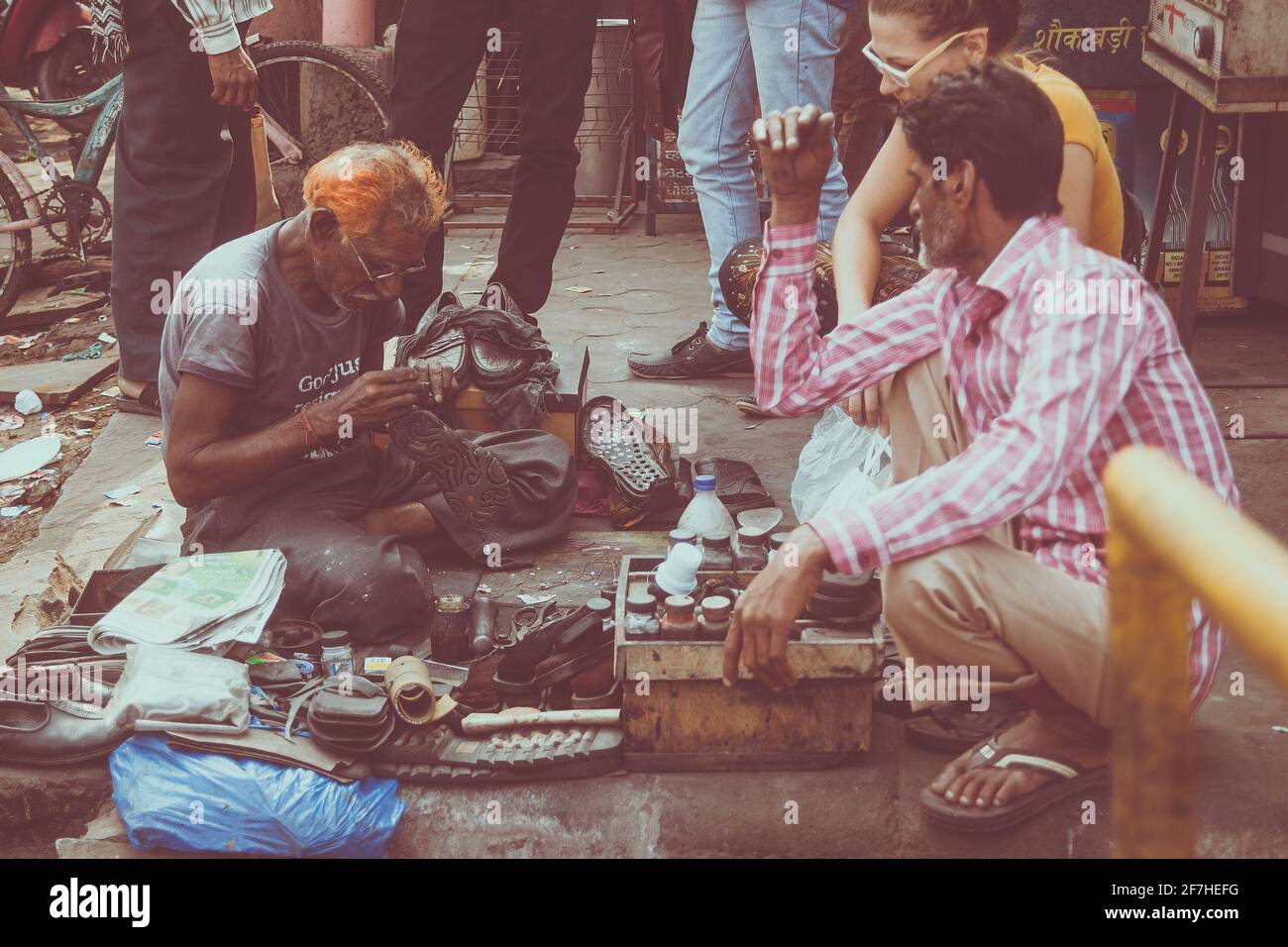 JAIPUR, INDIA, 12 DECEMBER 2016: Vintage photo of a man fixing shoes on ...
