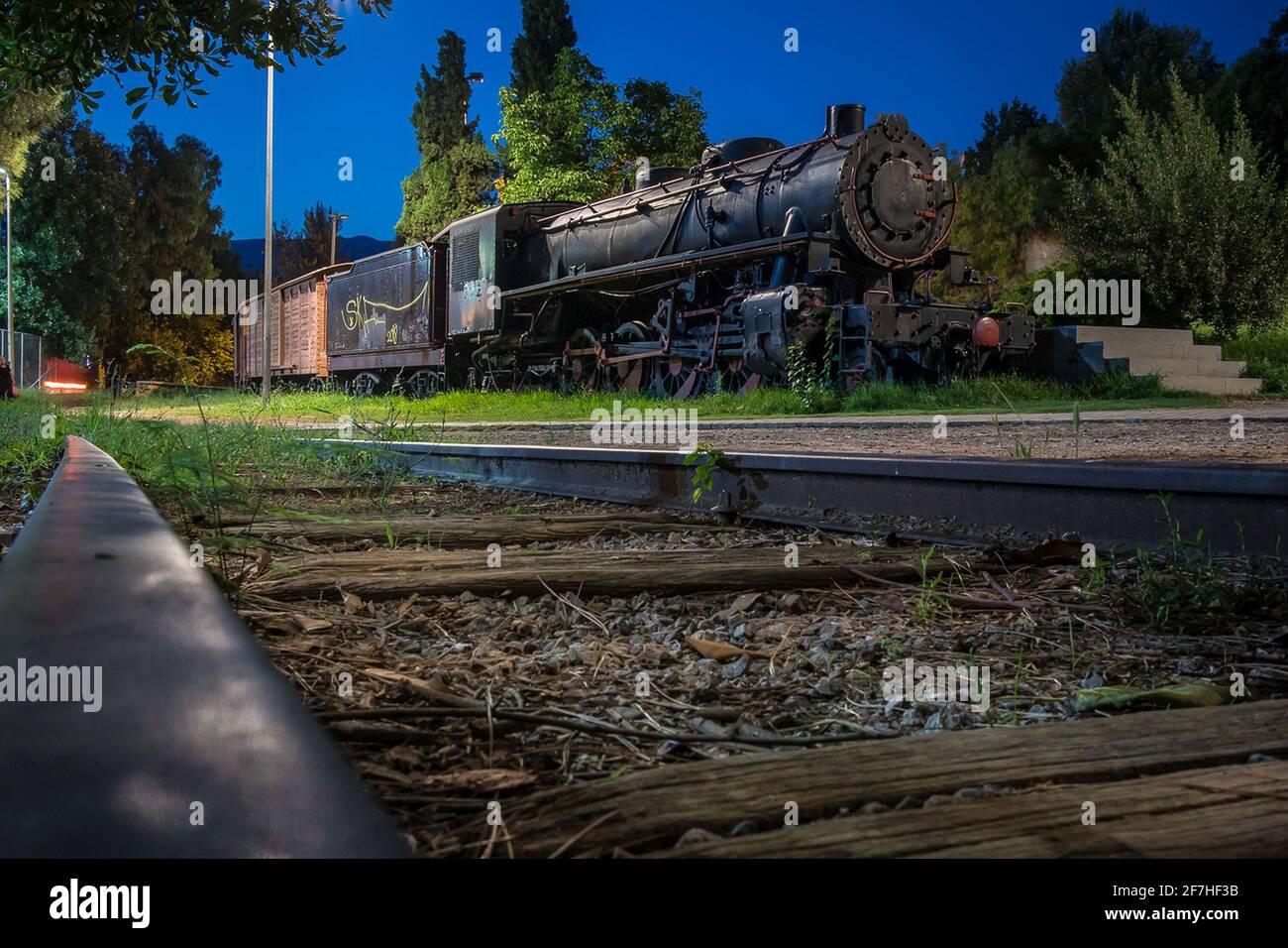 Old steam train at night parked as an outdoor exhibition of railways in ...