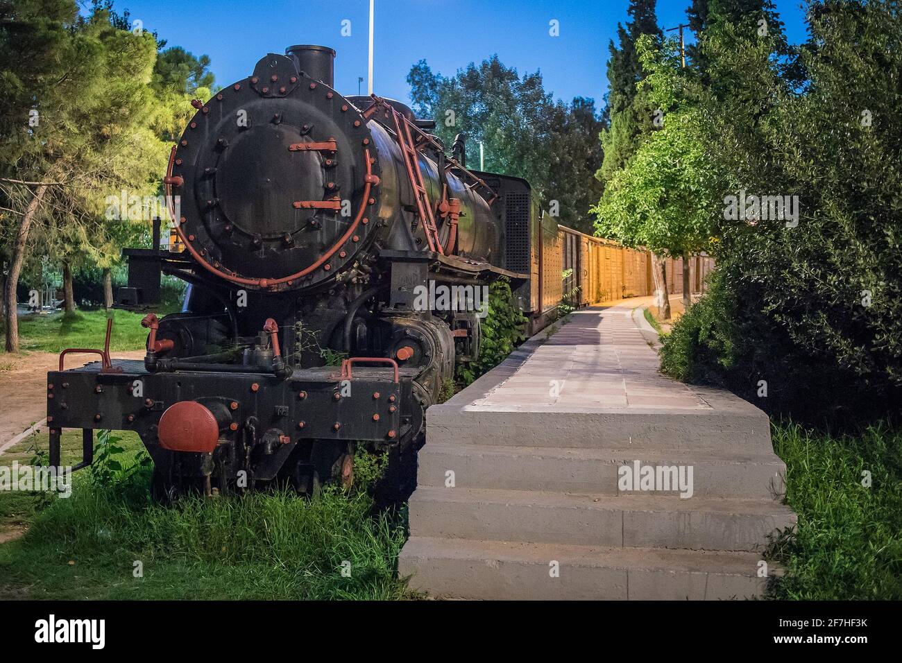 Old steam train at night parked as an outdoor exhibition of railways in ...