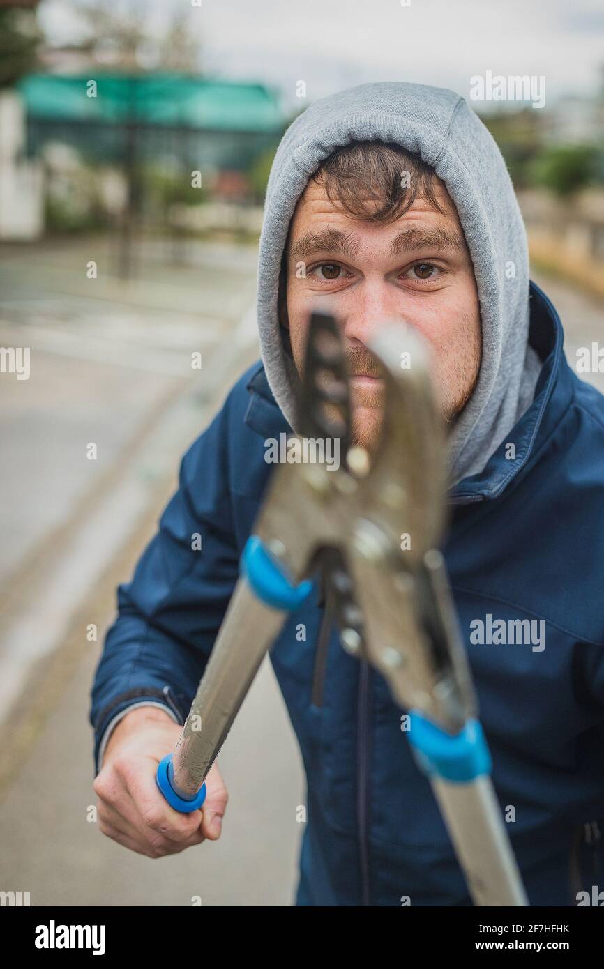 Crazy deranged man with long pruning scissors in his hands attacking ...