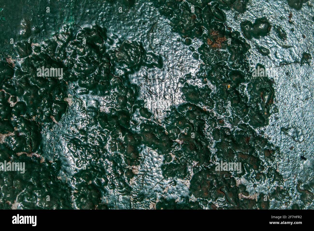 Pitted green metal surface due to rust corrosion on a boat or ferry ...