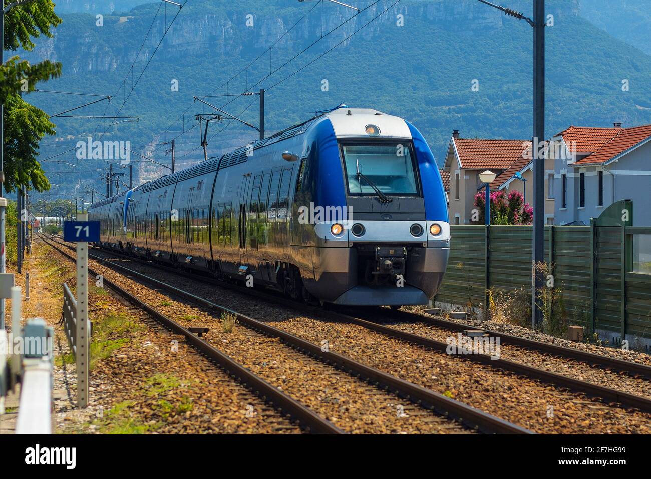 A fast commuter passenger train in France in blue and silver color ...