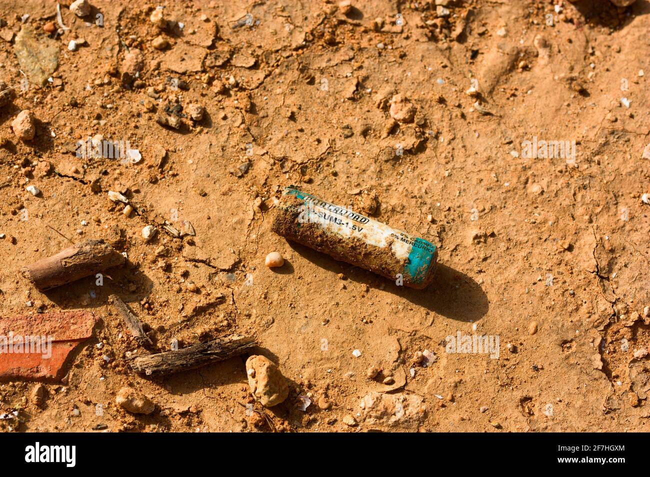 Close-up of a damaged battery abandoned on the groundA used and totally ...