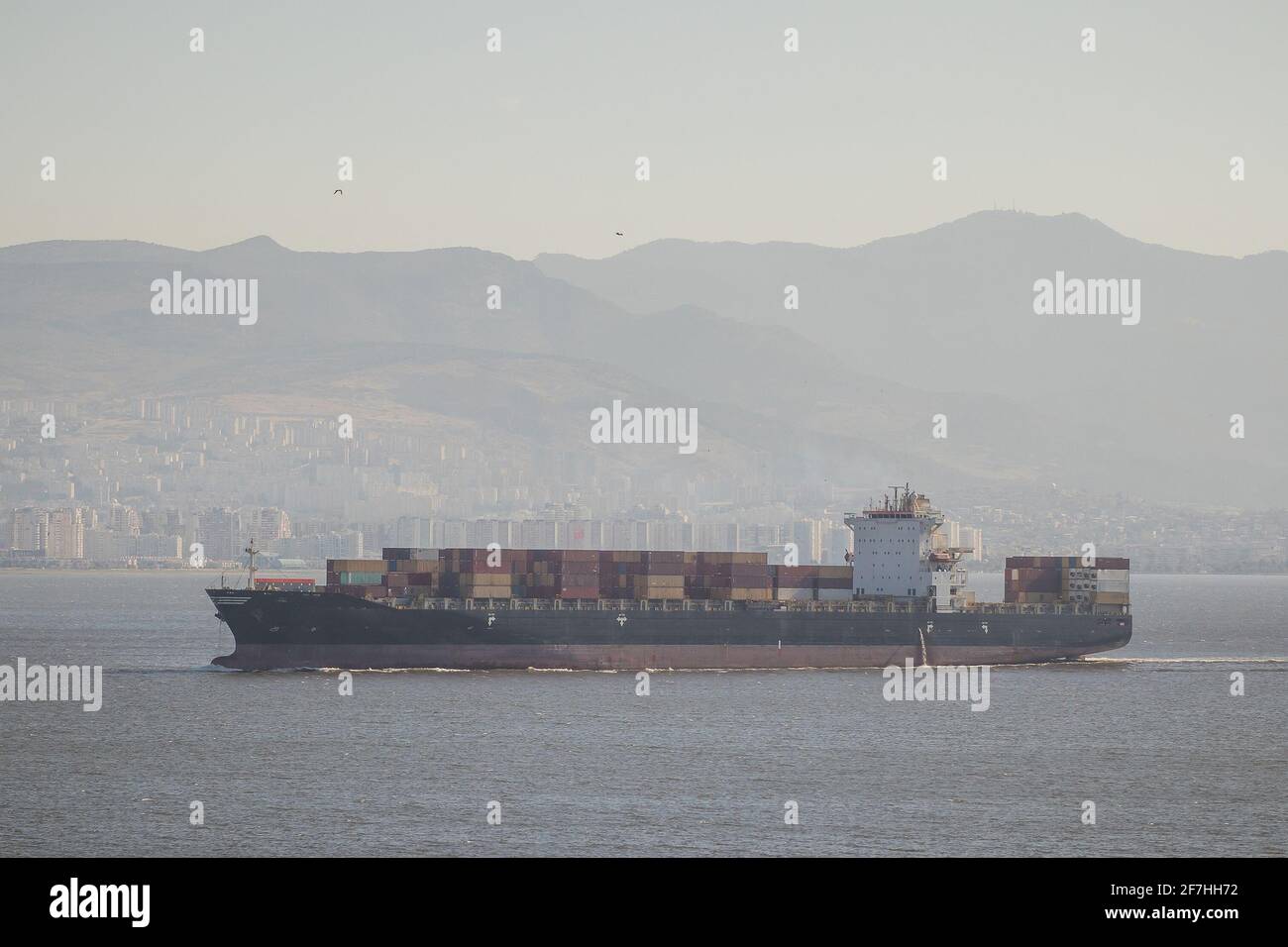 A big container cargo ship or carrier traveling from the Port of Izmir ...