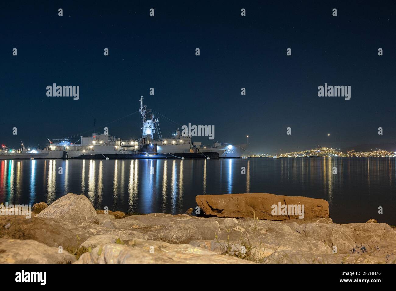 Late night panorama of a F 256 war ship and a submarine moored as a ...