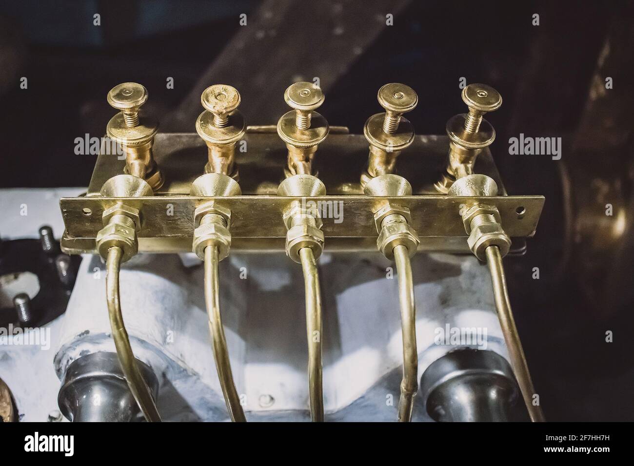 Metal or copper brass piping with check valves on top, in an old steam ...