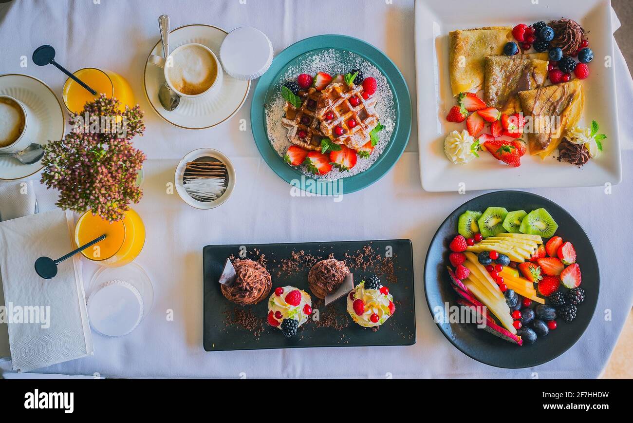 An assortiment of different delicious breakfast options. Fruit, waffles ...