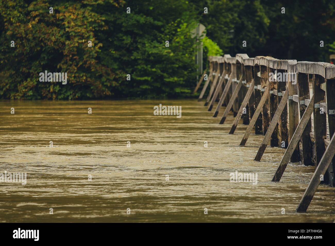 Flooded wooden trestle bridge with road, due to heavy rain and bad ...