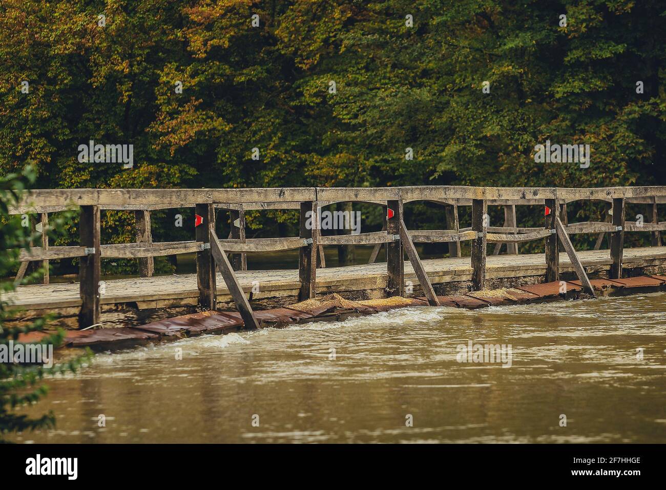 Flooded wooden trestle bridge with road, due to heavy rain and bad ...