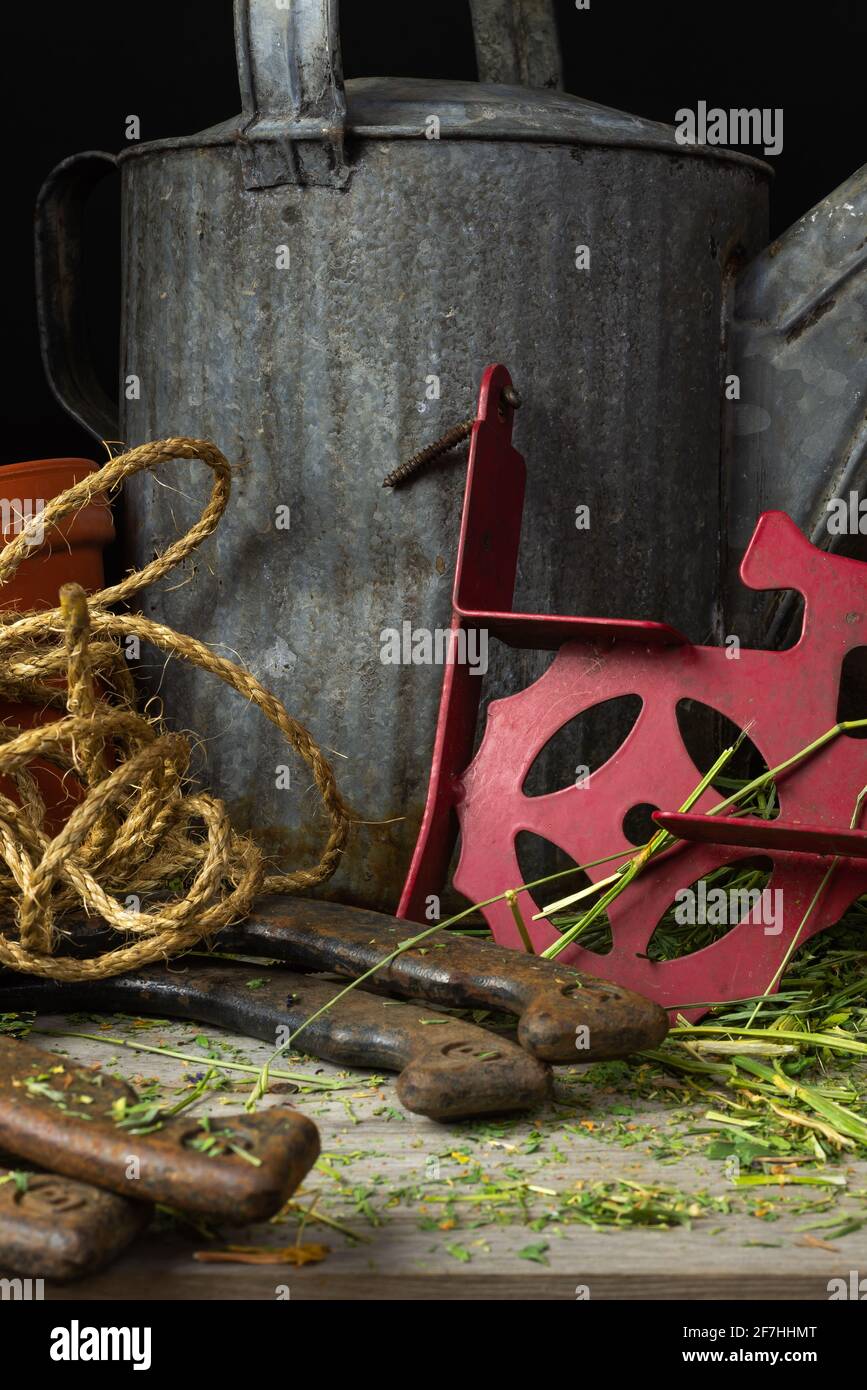 Rusted and worn farm items on hay covered wood floor Stock Photo - Alamy