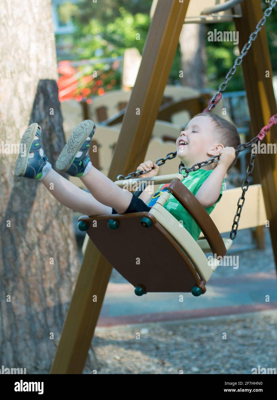 Happy boy riding on swing hi-res stock photography and images - Alamy