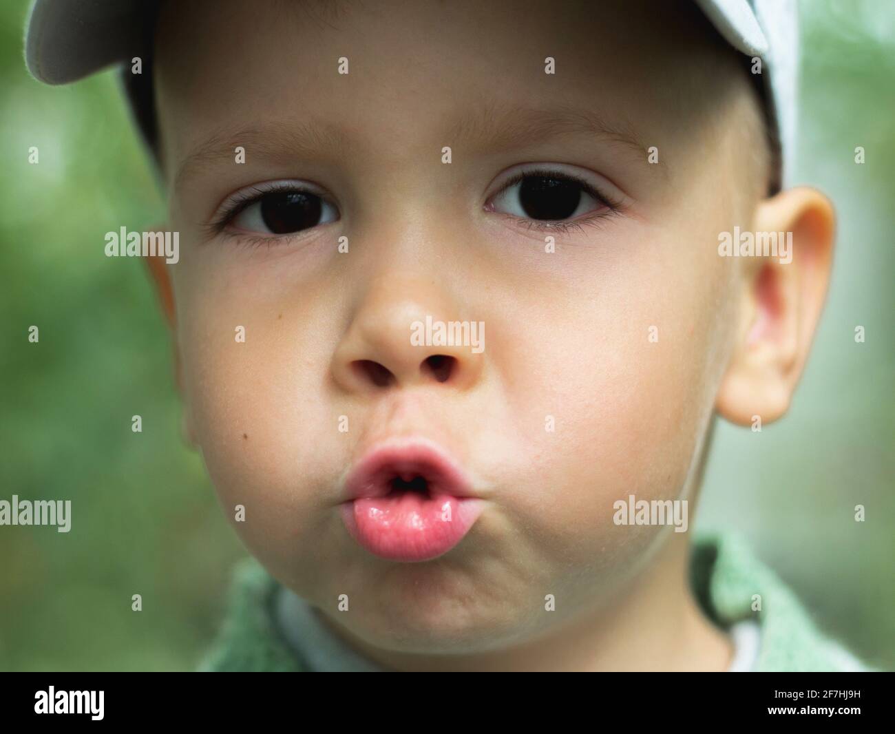 The child look into the camera in the greenhouse Stock Photo - Alamy