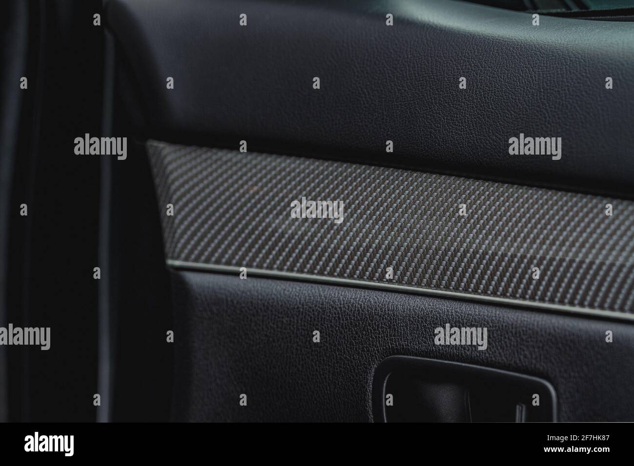 Modern car door close up view with leather and carbon details. Car ...