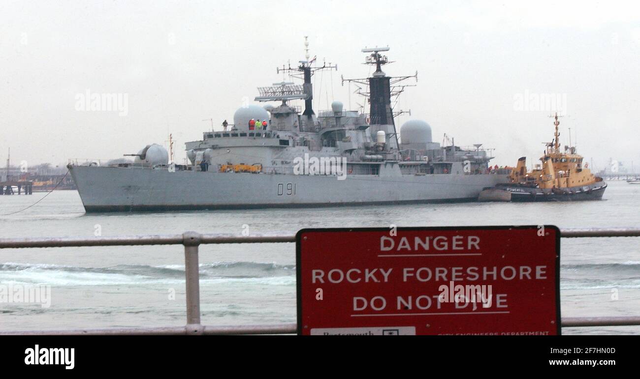 HMS NOTTINGHAM , BACK IN THE WATER, IS TOWED INTO PORTSMOUTH NAVAL BASE ...