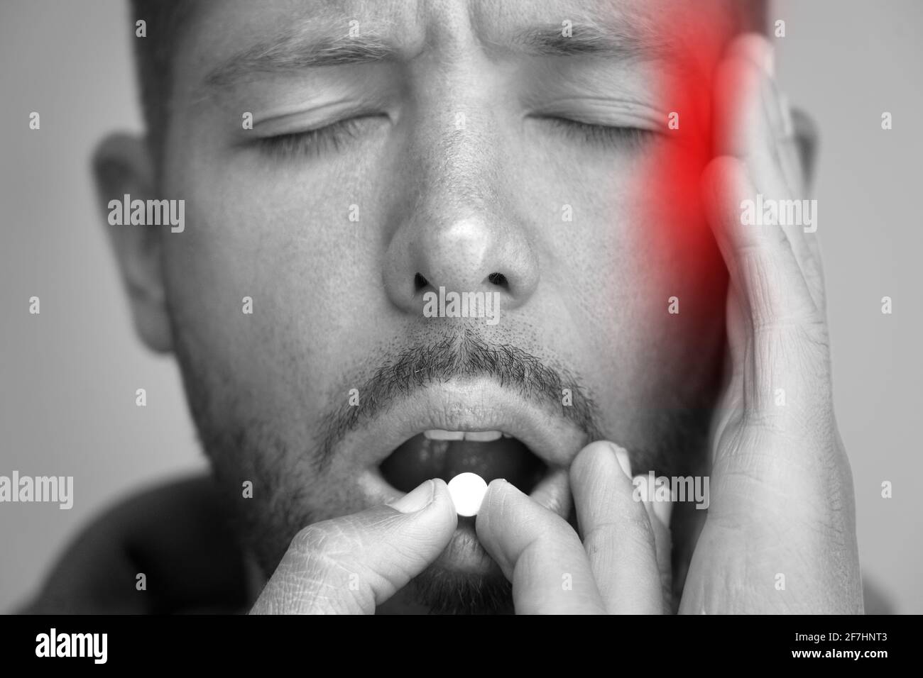 Man suffering from headache and taking painkillers to relieve pain ...