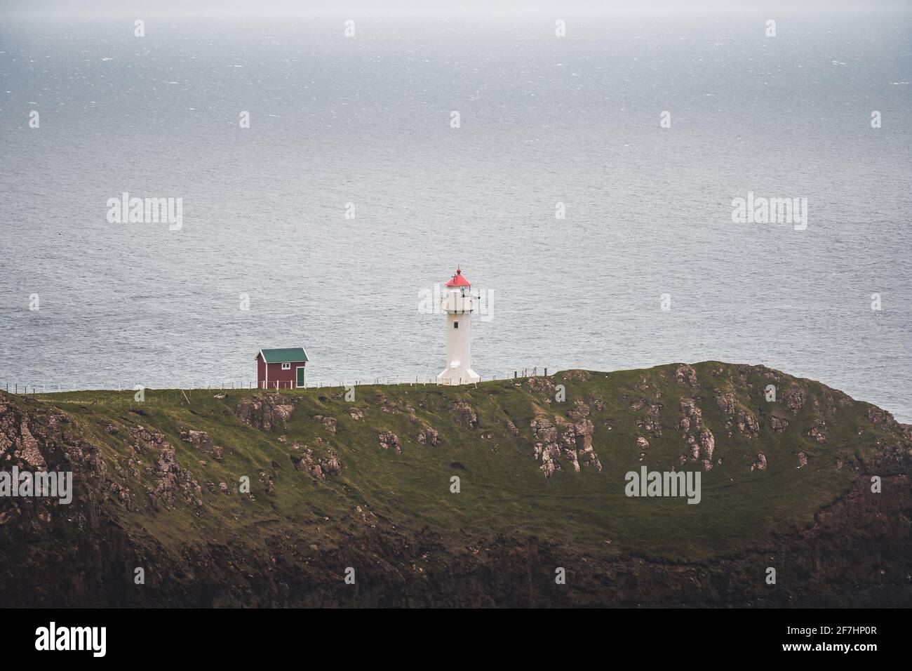 View towards orange house on Akraberg lighthouse at Suduroy island at ...