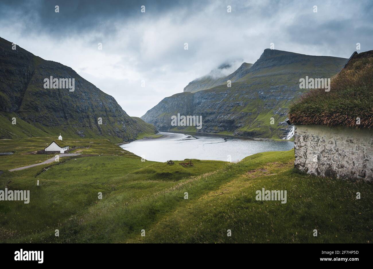 The old Lutheran church in Saksun village with view over the saksun ...