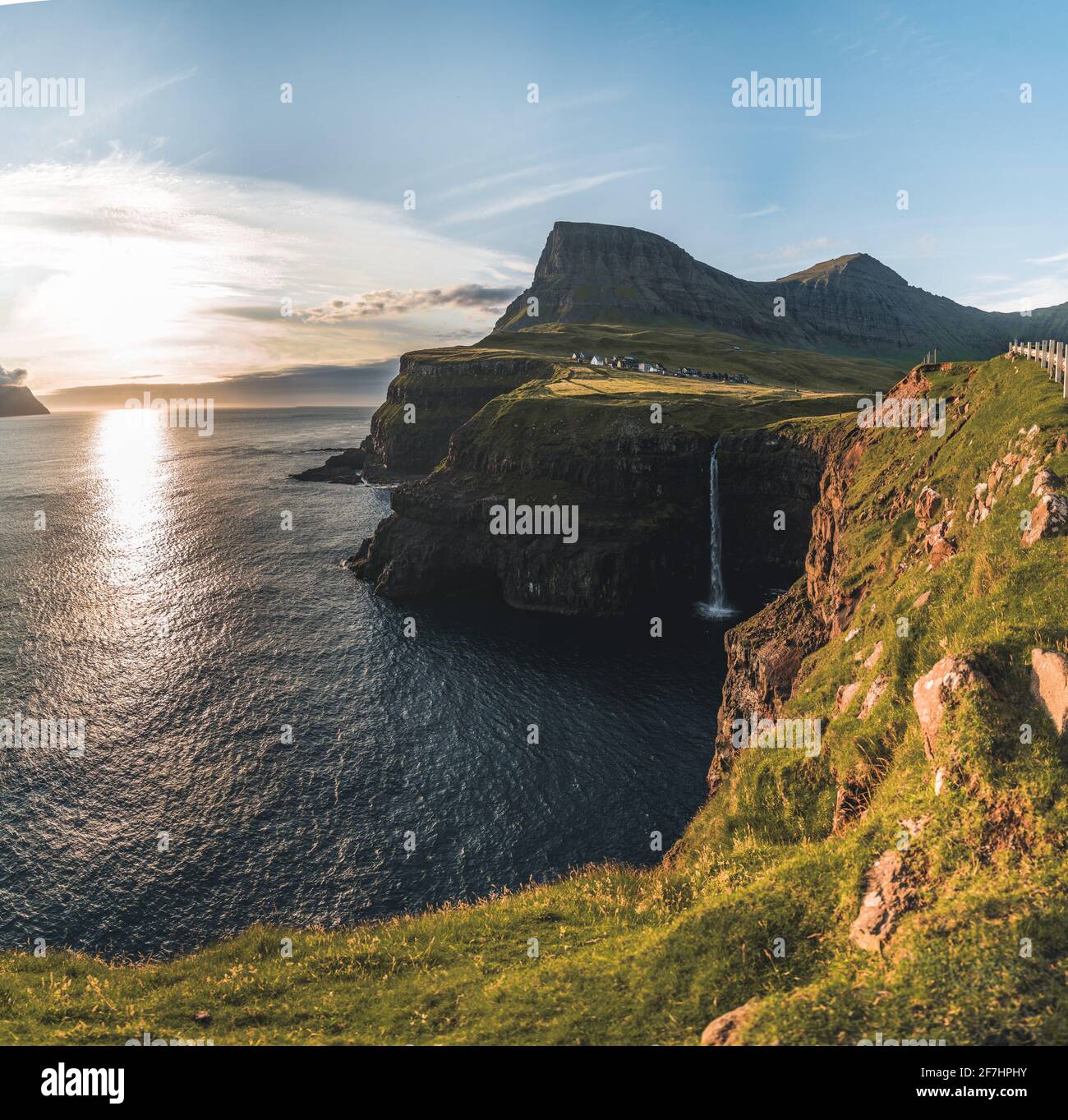 Gasadalur village and Mulafossur its iconic waterfall during summer ...