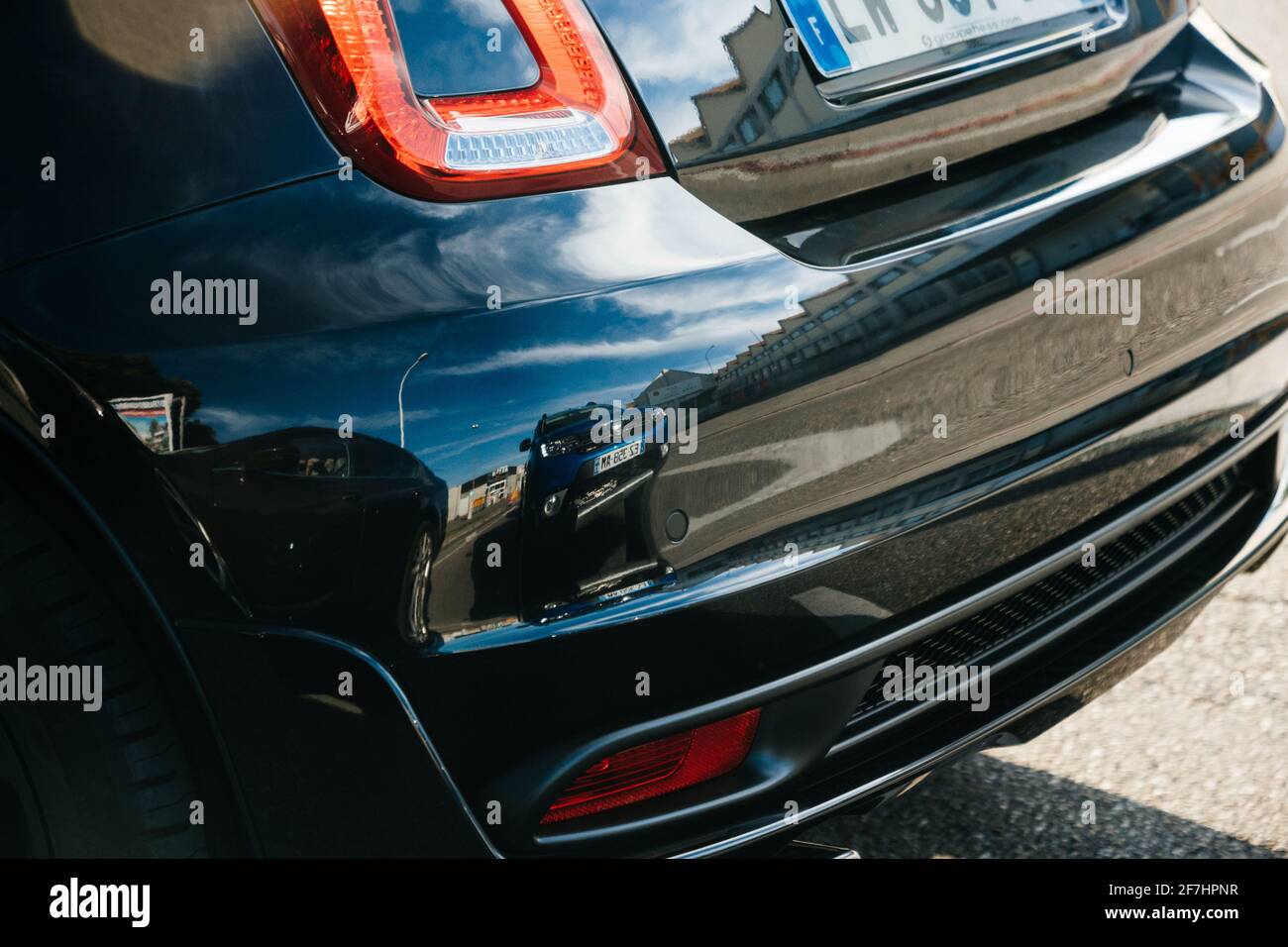 reflection of new Dacia Duster SUV car in the rear part of a Fiat 500 ...