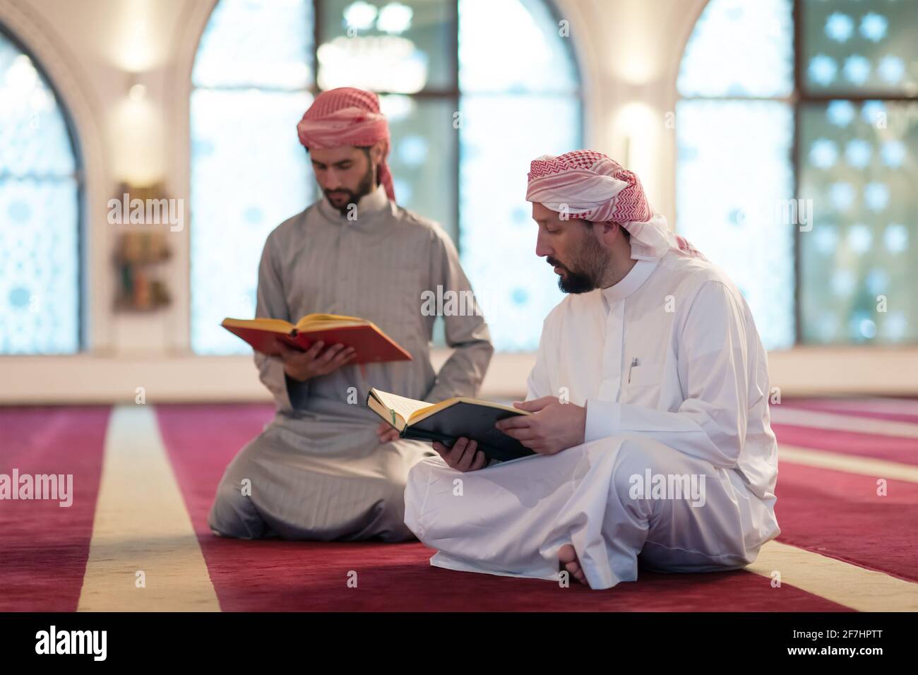 two muslim people in mosque reading quran together concept of islamic ...