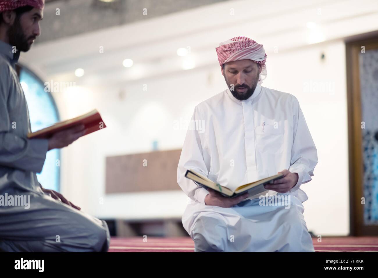two muslim people in mosque reading quran together concept of islamic ...