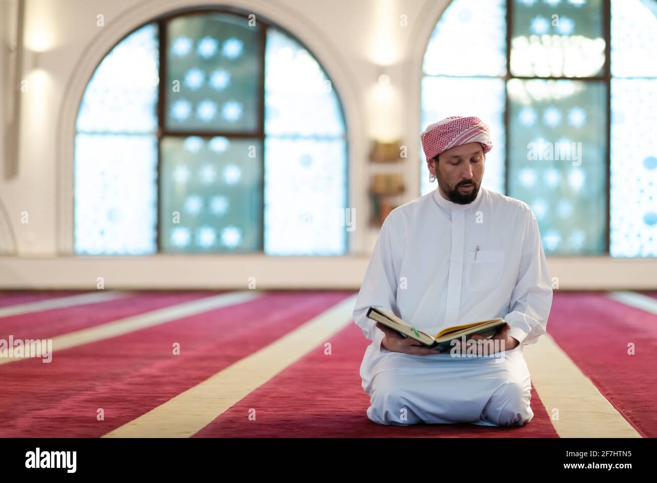 muslim man praying Allah alone inside the mosque and reading islamic ...