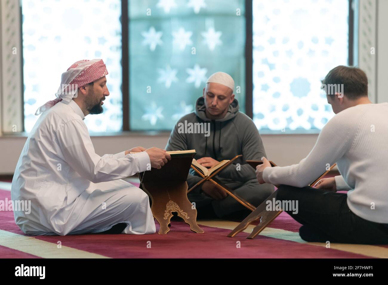 muslim people in mosque reading quran together Stock Photo - Alamy