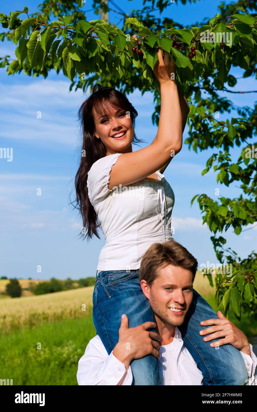 Young man eating cherries in hi-res stock photography and images - Alamy