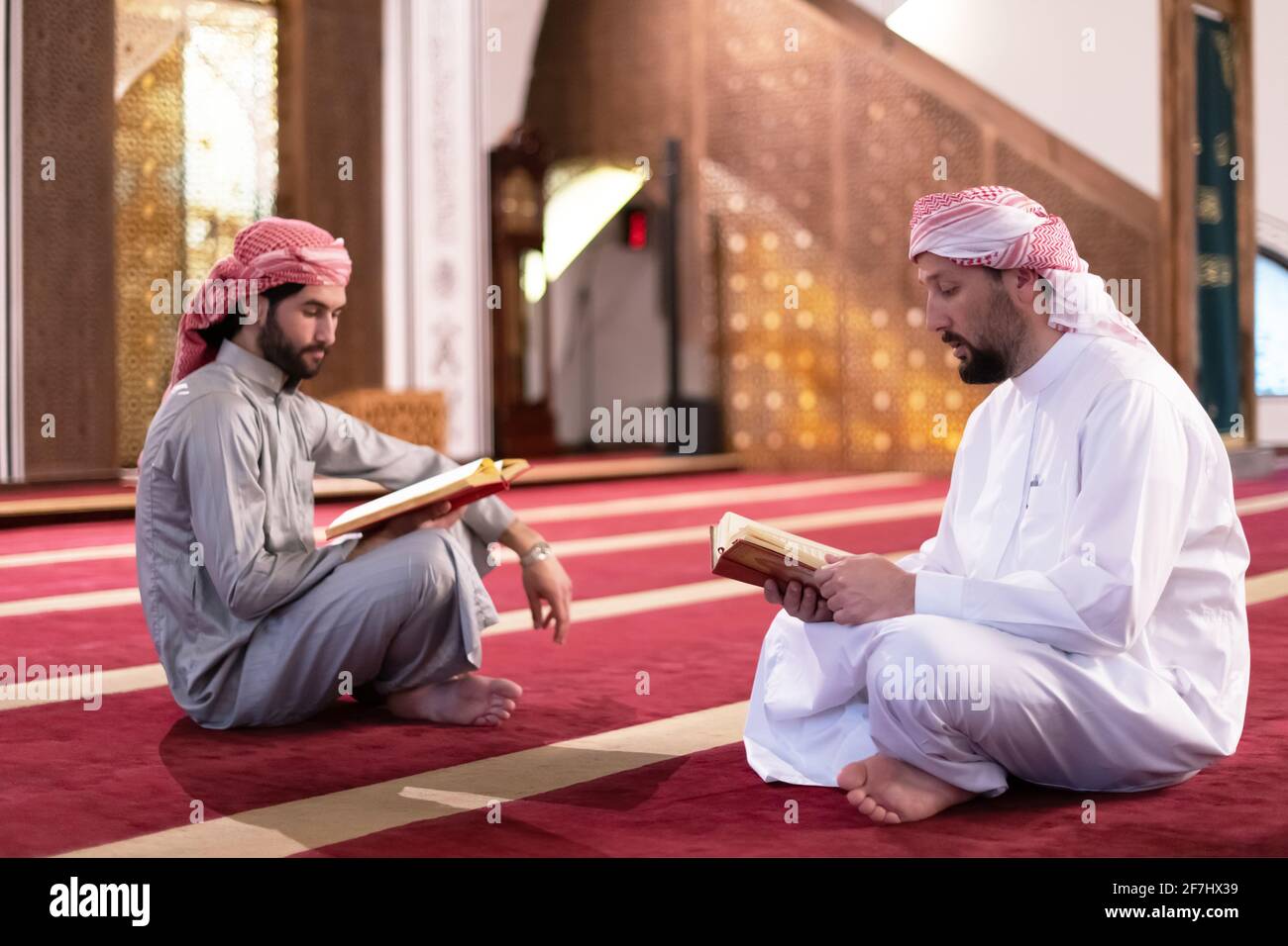 two muslim people in mosque reading quran together concept of islamic ...