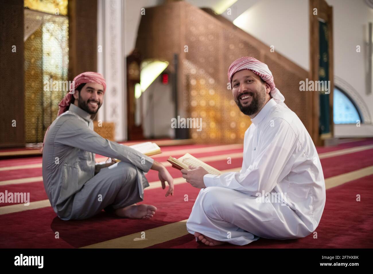 two muslim people in mosque reading quran together concept of islamic ...
