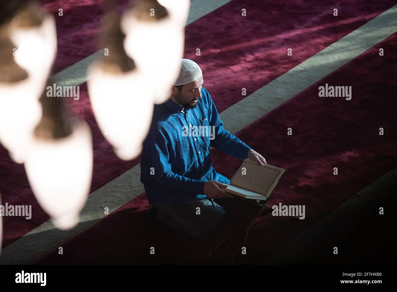 muslim man praying Allah alone inside the mosque and reading islamic ...