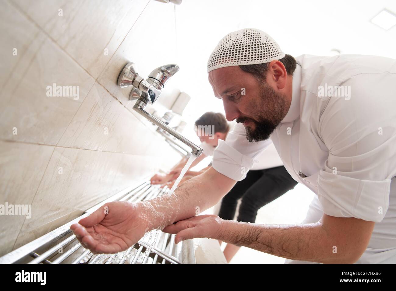 a group of Muslims take ablution for prayer. Islamic religious rite ...