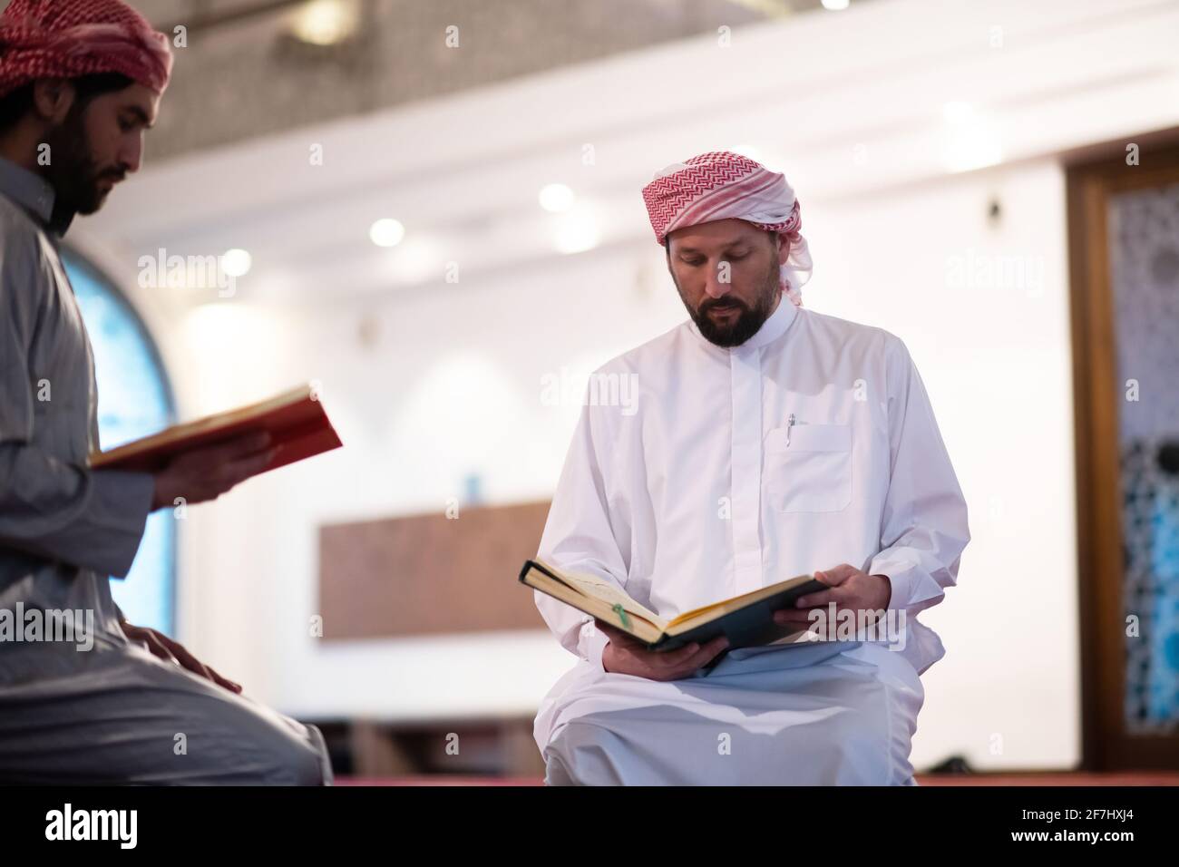 two muslim people in mosque reading quran together concept of islamic ...