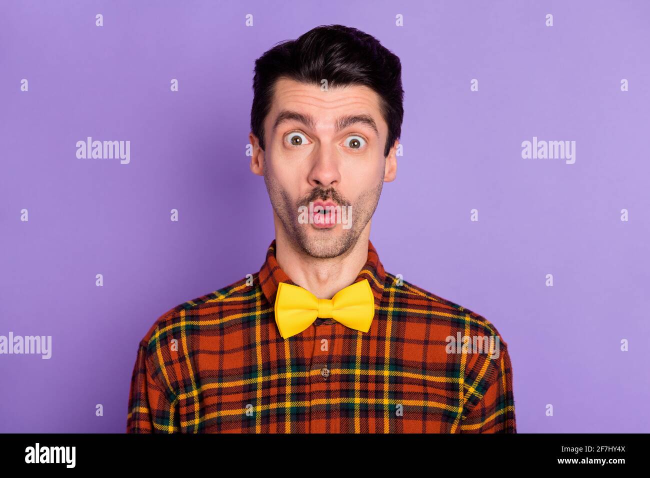 Portrait of attractive amazed brunet funky guy wearing checked shirt ...