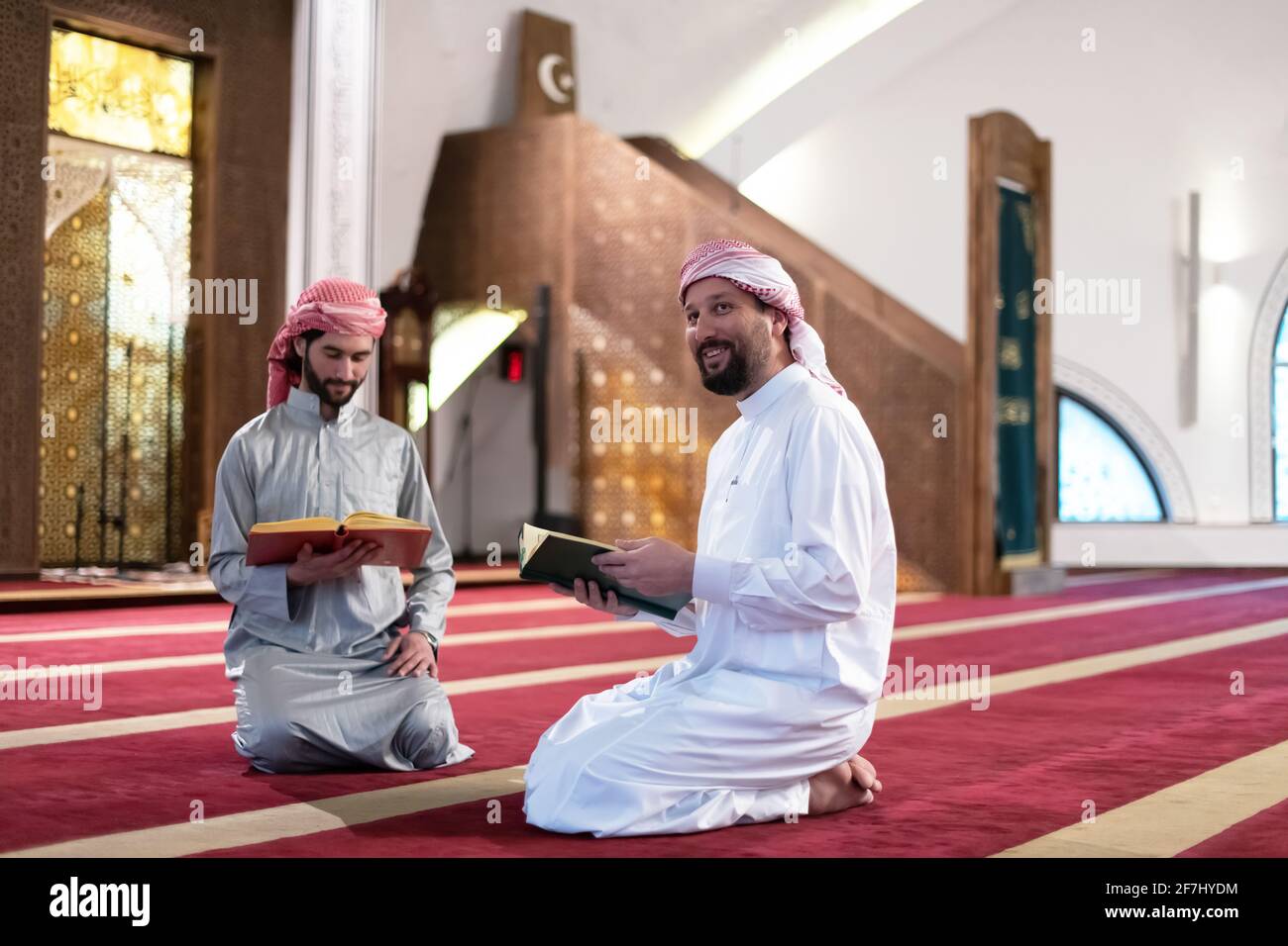 two muslim people in mosque reading quran together concept of islamic ...
