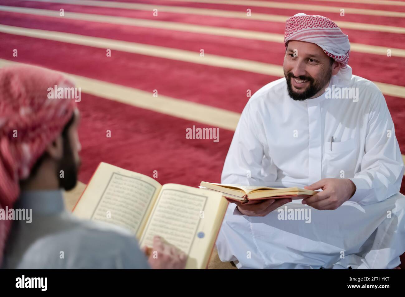 two muslim people in mosque reading quran together concept of islamic ...