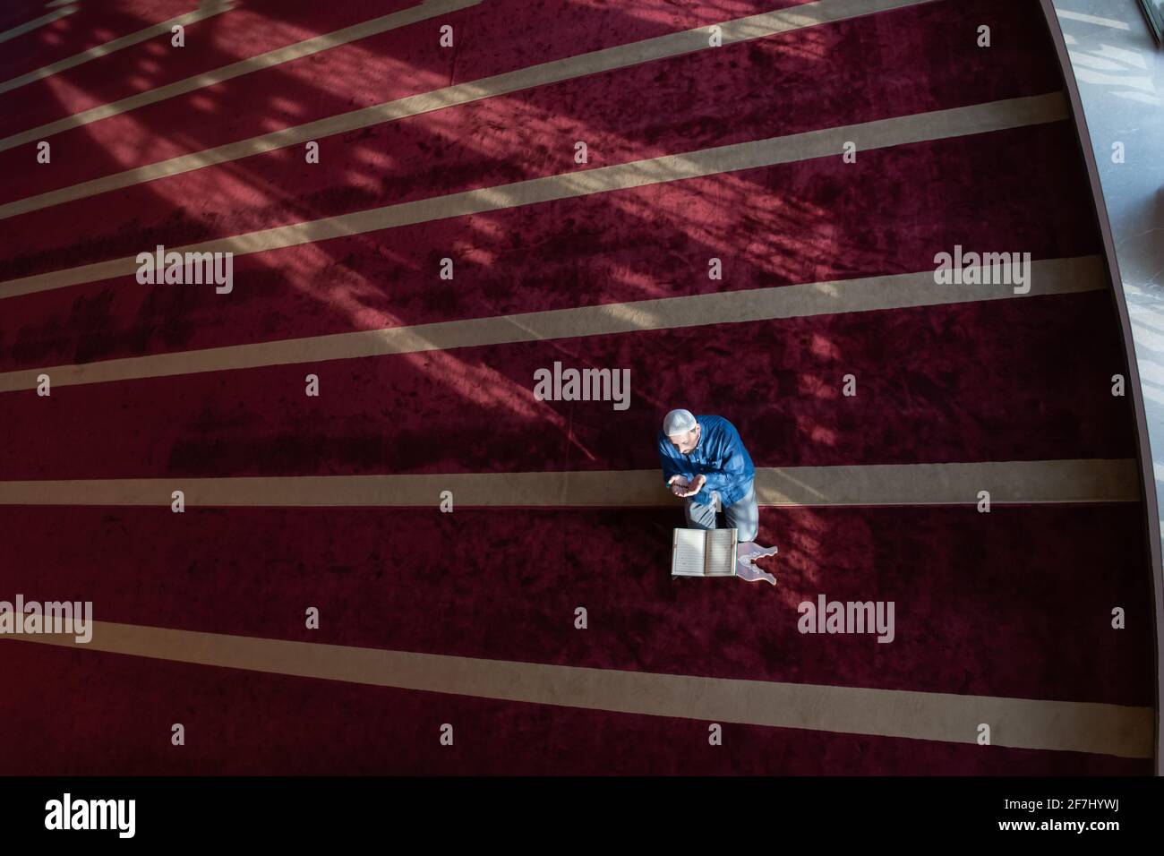 muslim man praying Allah alone inside the mosque and reading islamic ...