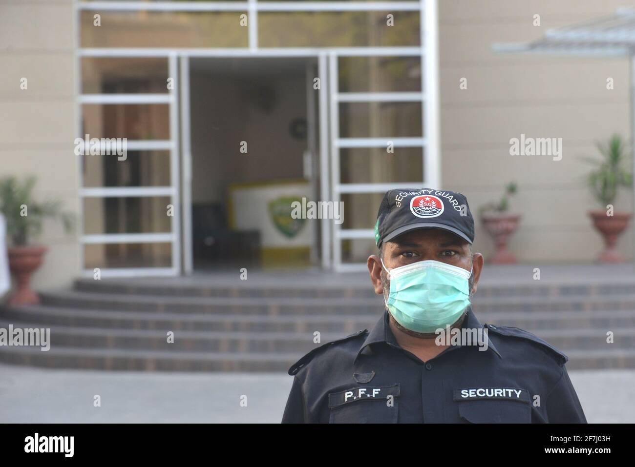 A security guard stands at the main entrance of the headquarters of ...