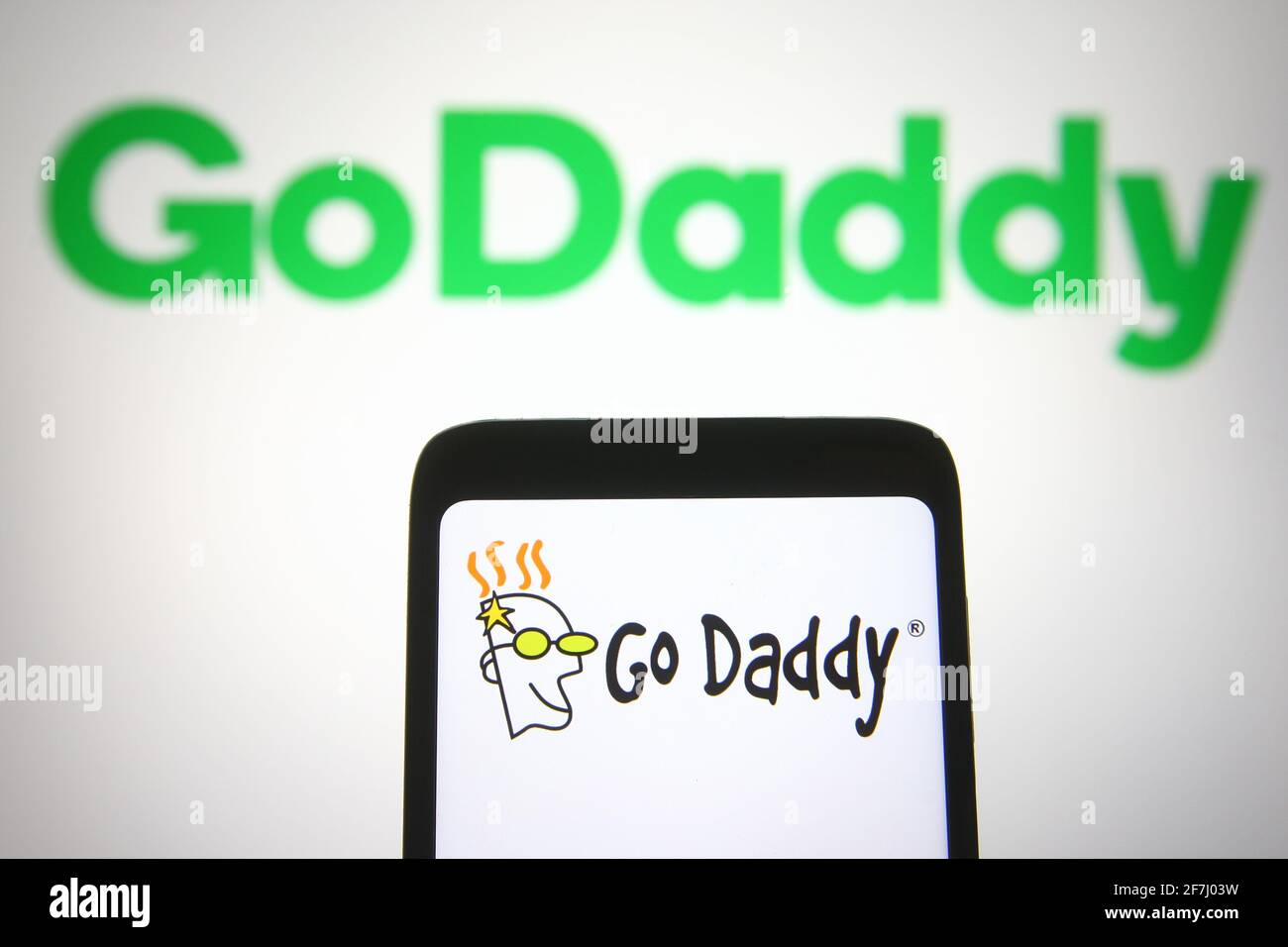 In this photo illustration the GoDaddy logo is seen on a smartphone and ...