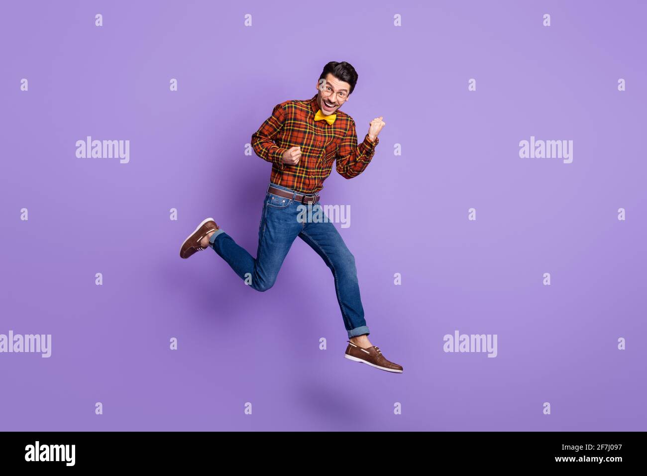 Full size photo of young handsome cheerful smiling positive man jumping ...