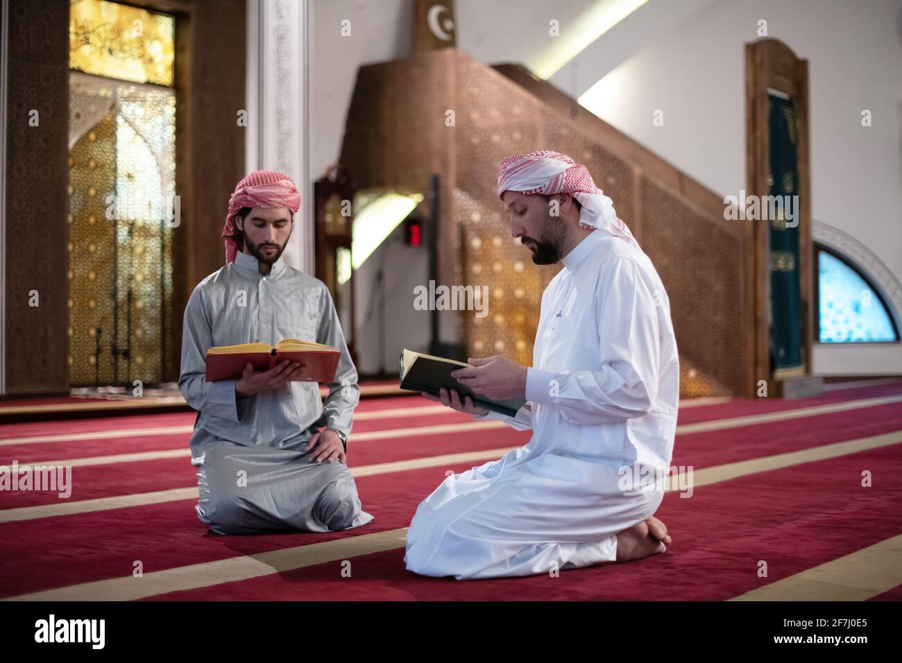 two muslim people in mosque reading quran together concept of islamic ...
