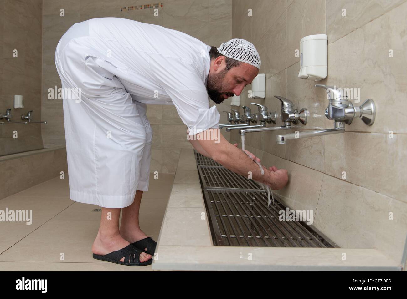 A Muslim takes ablution for prayer. Islamic religious rite Stock Photo ...