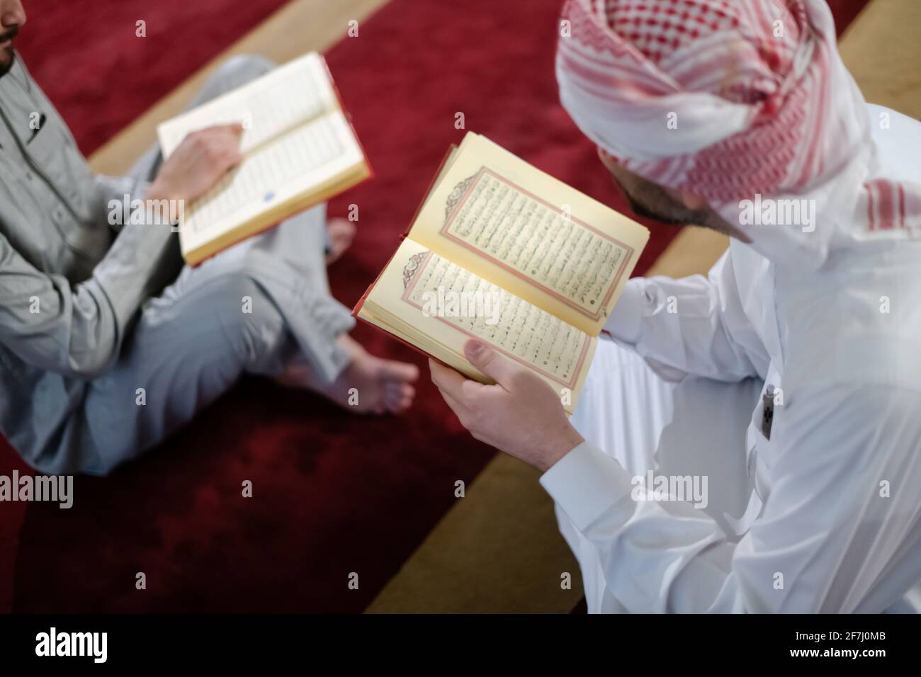 two muslim people in mosque reading quran together concept of islamic ...