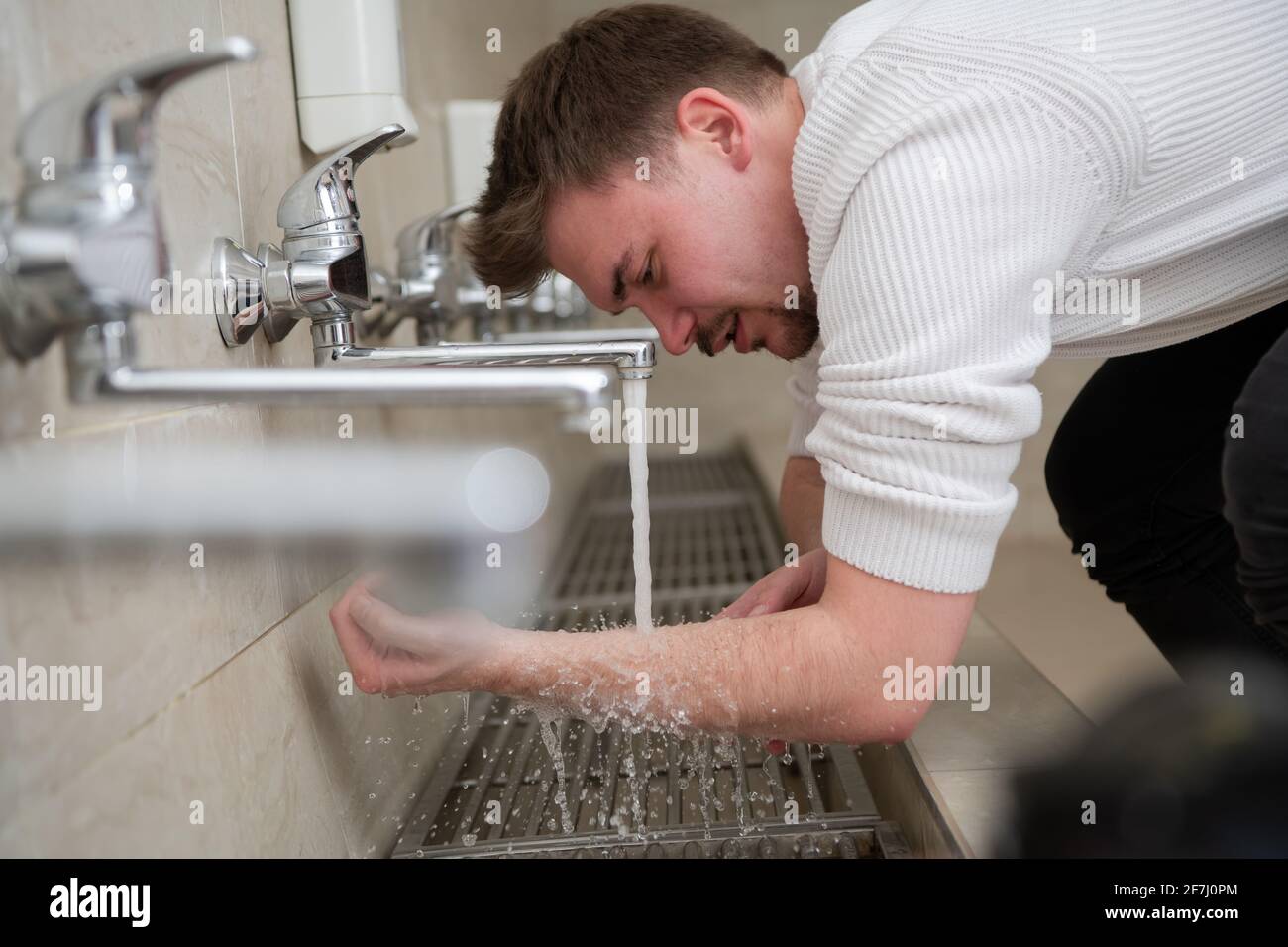 A Muslim takes ablution for prayer. Islamic religious rite Stock Photo ...